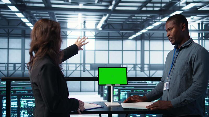 Engineers Overseeing Server Room With Mockup Device Reading Hardware