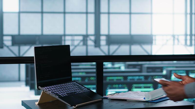 Technician In Data Center With Laptop And Tablet Integrating Ai Driven Automation Tools Server