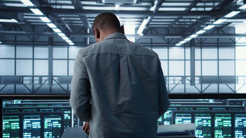 Engineer In Data Center Coding On Laptop Optimizing Resource Utilization Adjusting Power