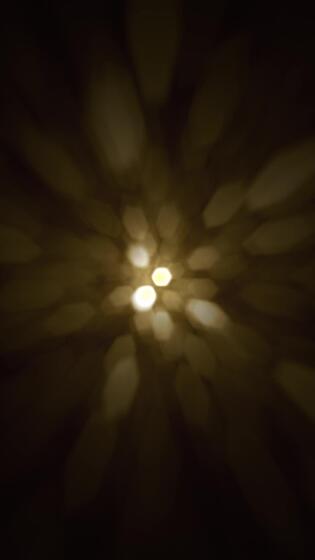Defocused golden bokeh lights vertical background. This elegant motion background animation with ...