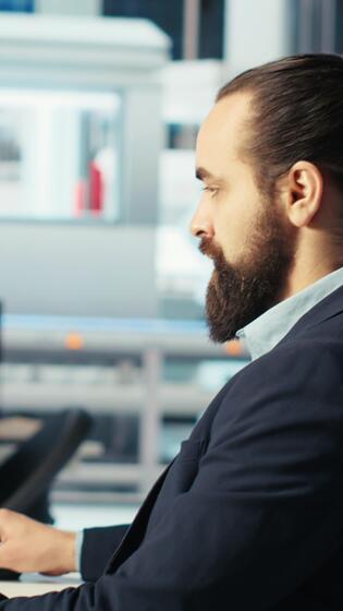 Vertical Engineer In Photovoltaics Factory Using Pc Screen To Diagnose Malfunctioning Systems