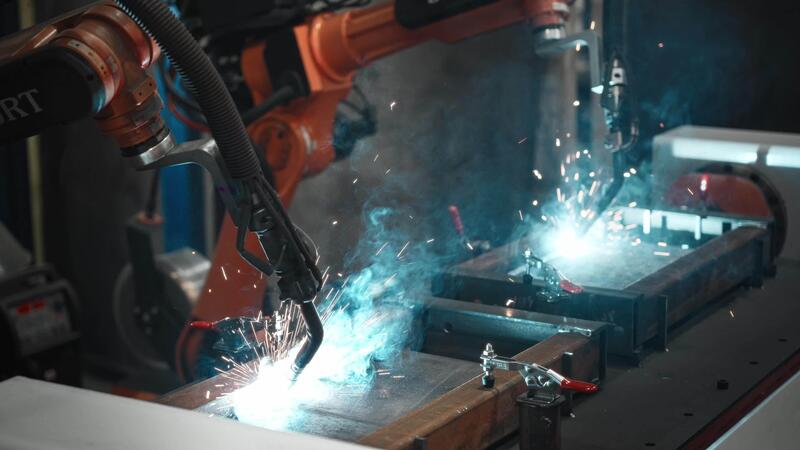 Automatic welding of steel parts using a robotic arm. Robotization and automation of production ...