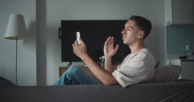 Man using smartphone for chat, bridging personal or professional connections, enabling instant ...