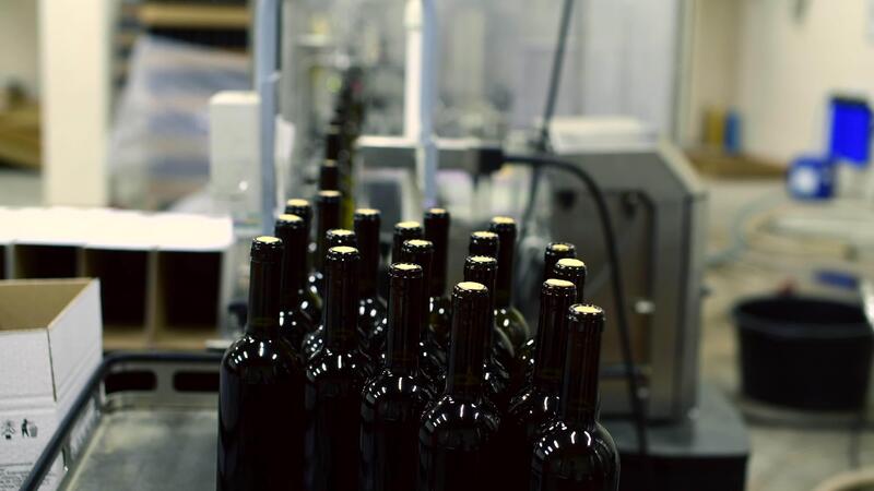Wine bottle conveyor system in operation showcasing the bottling process at a factory 59873649 ...
