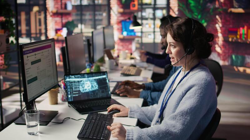 Call center worker using artificial intelligence customer service management software. Customer ...