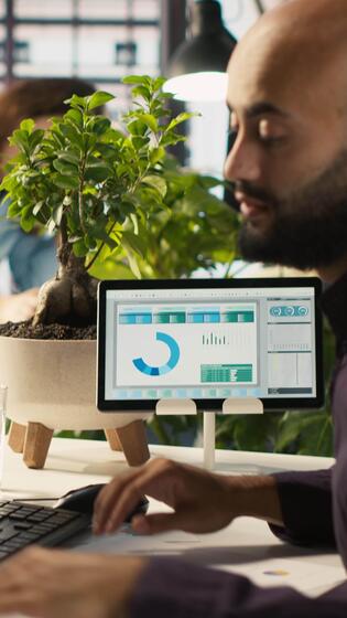 Vertical Employee Editing Documents On Desktop Computer At Office Desk Updating Reports And
