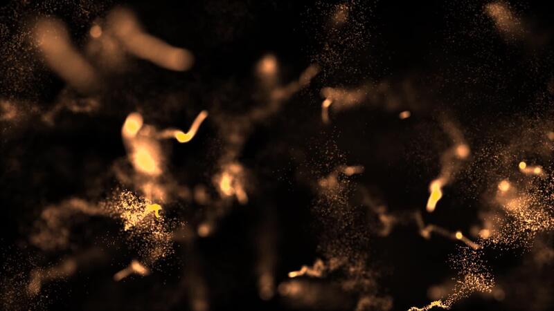 Abstract background with exploding glittering shiny gold particles and shallow depth of field ...