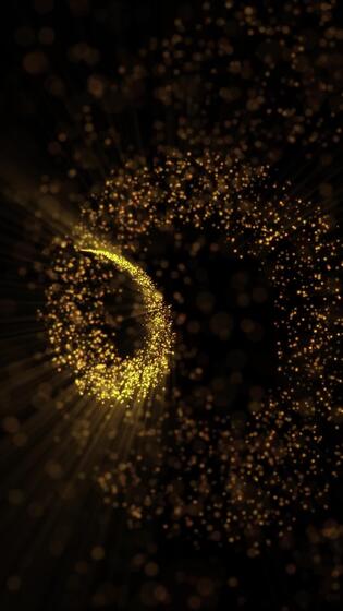 Abstract background with spiraling glittering shiny gold particles and shallow depth of field ...