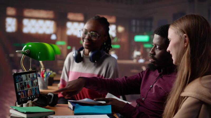 Group of diverse pupils engaging in online course via call, participating at the remote class ...