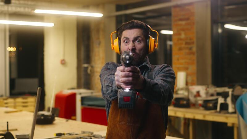 Expressive Caucasian handyman man wood master drilling electric ...