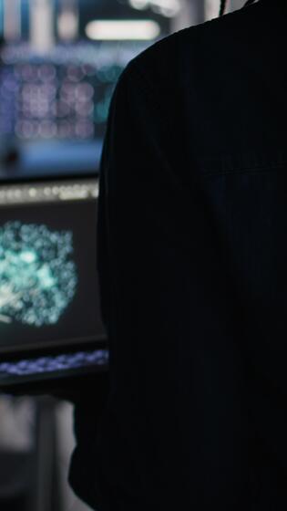 Vertical Server hub technician arriving in office, using AI visualization insights on PC to ...