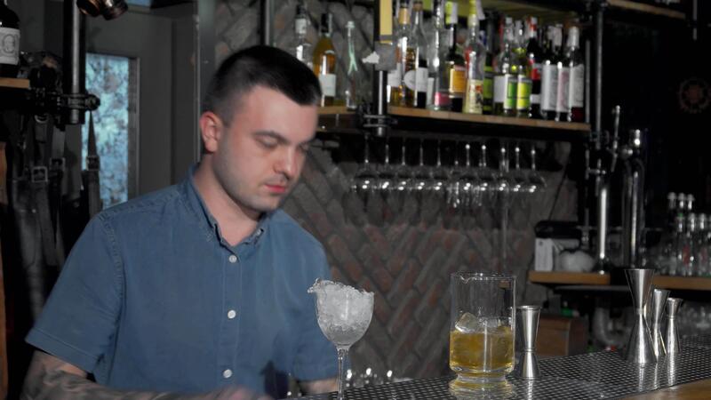 Skilled bartender expertly crafting a vibrant cocktail at the bar 63215027 Stock Video at Vecteezy