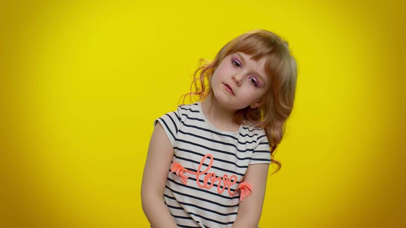 Upset tired sad child kid girl leaning on hand looking at camera with ...