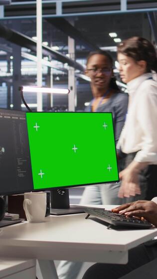 Vertical Data center admin inspecting gear using green screen mockup PC, doing maintenance tasks ...
