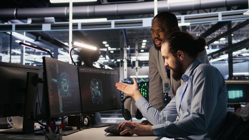 Supervisor In Server Room Monitoring Worker Managing Ai Training Datasets African American Team