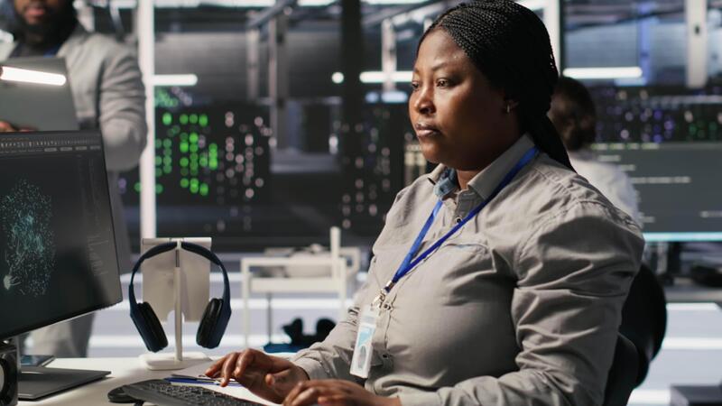 Data center programmer coding on PC, doing software updates for AI ...