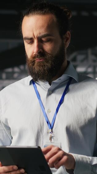 Vertical Server room technician next to coworkers reviewing neural network code and LLM ...