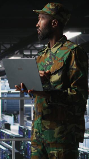 Vertical Army information technology specialist in data center troubleshooting military computer ...