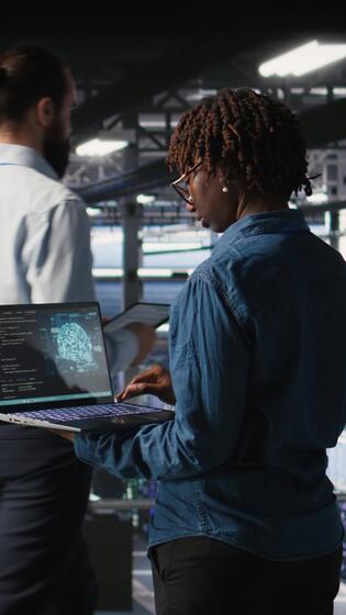 Vertical System administrators in data center monitoring AI LLM visualization. African american ...