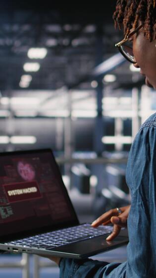 Vertical Data center programmer panicking after receiving critical error popup on laptop display ...