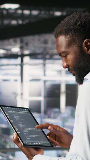 Vertical Data Center Programmers On Industrial Platform Checking Lines Of Code Collaborating On