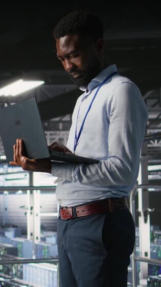 Vertical Engineers In Data Center Using Laptop To Monitor Neural Network Llm Visualization