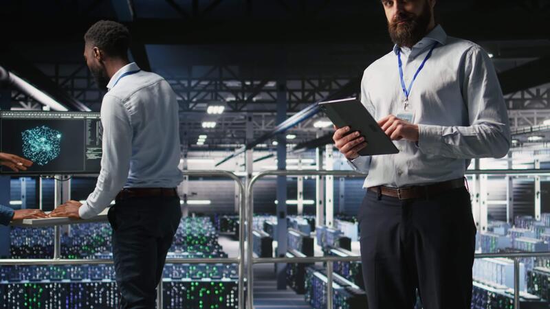 Portrait Of Smiling Engineer In Data Center Monitoring Neural Network
