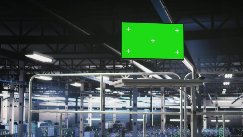 Elevated industrial data center control station green screen display showing analytics from ...