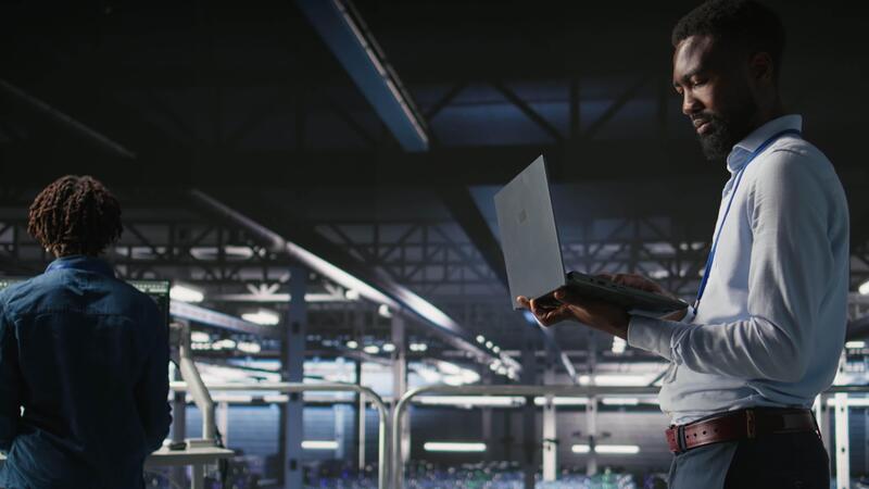 Technicians on data center industrial platform analyzing performance outputs after completing ...