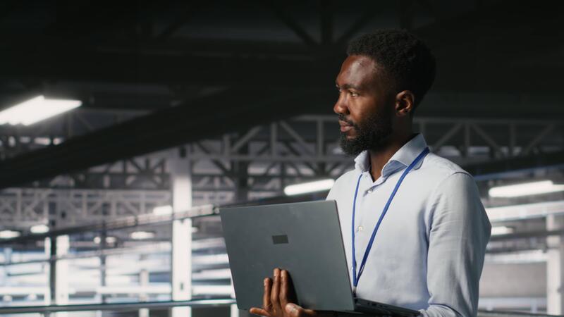 Engineers In Data Center Using Laptop To Monitor Neural Network Llm