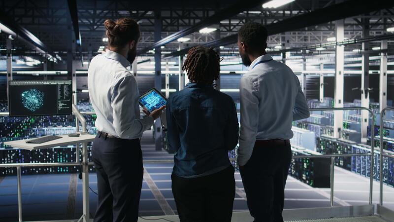 Software developers in data center monitoring AI LLM visualization. Server farm teamworking ...