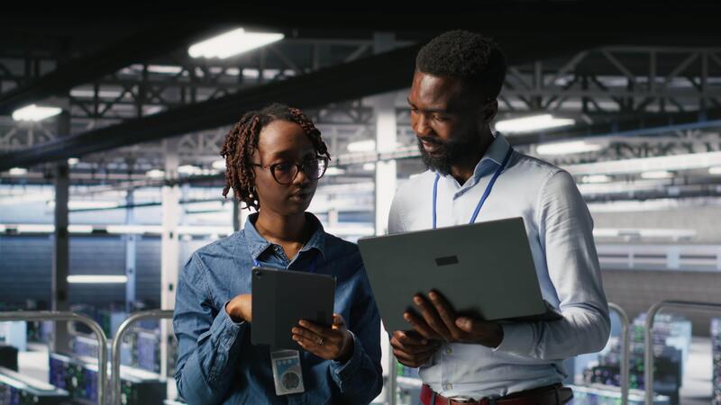 Data Center Admins Running Diagnostics On Equipment Using System Monitoring Tools To Identify