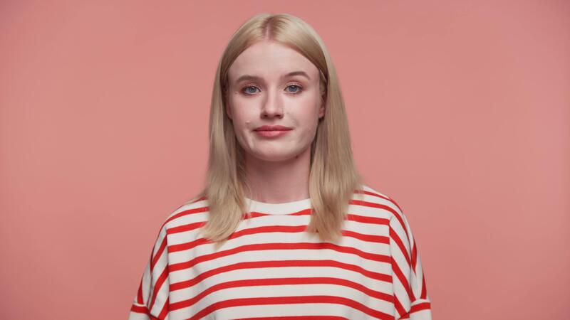 Woman making indifferent shrugging expression on Pink 67165657 Stock ...