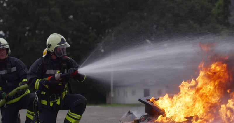 Firefighters fight the fire flame to control fire not to spreading out ...