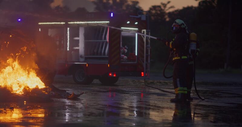 Firefighters fight the fire flame to control fire not to spreading out ...