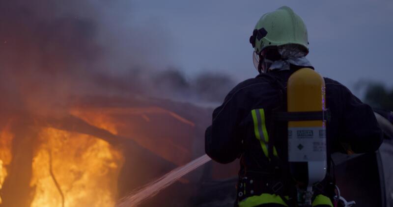 Firefighters fight the fire flame to control fire not to spreading out ...