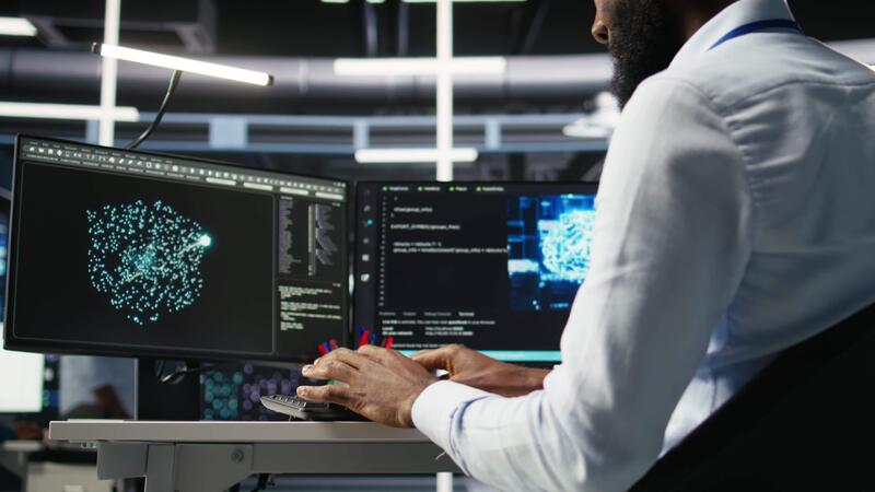 Vertical Data center computer scientist at desk using AI deep learning algorithms to analyze ...