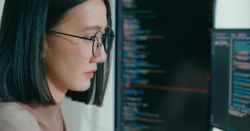 Closeup young adult Asia female freelance eyeglasses typing write prompt AI bot IT app program ...