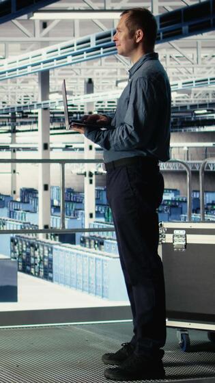 Vertical Data center software developers monitor deep learning processes, reviewing operational ...