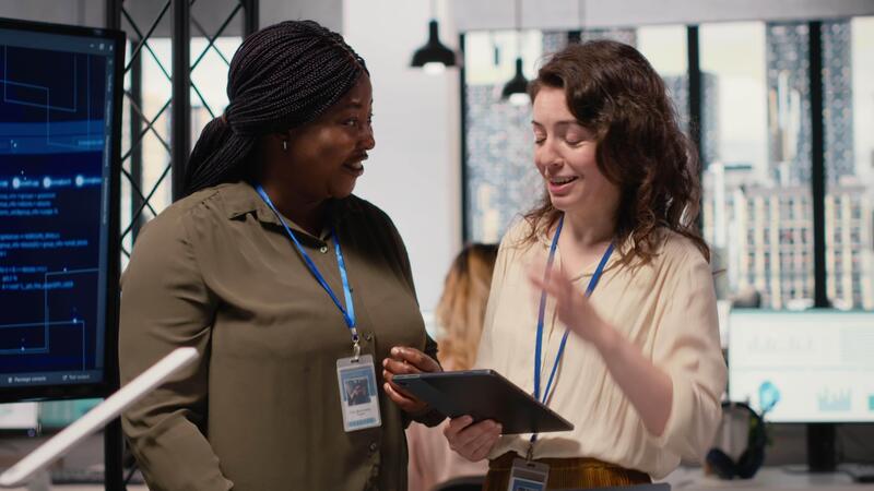 Diverse management staff reviewing advanced AI algorithms and predictive models to enhance ...