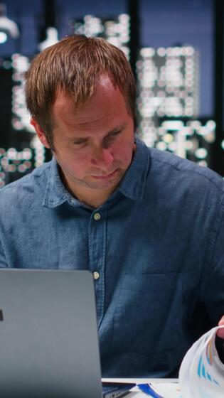 Vertical Startup employee consulting on a new corporate project with charts and files in the ...